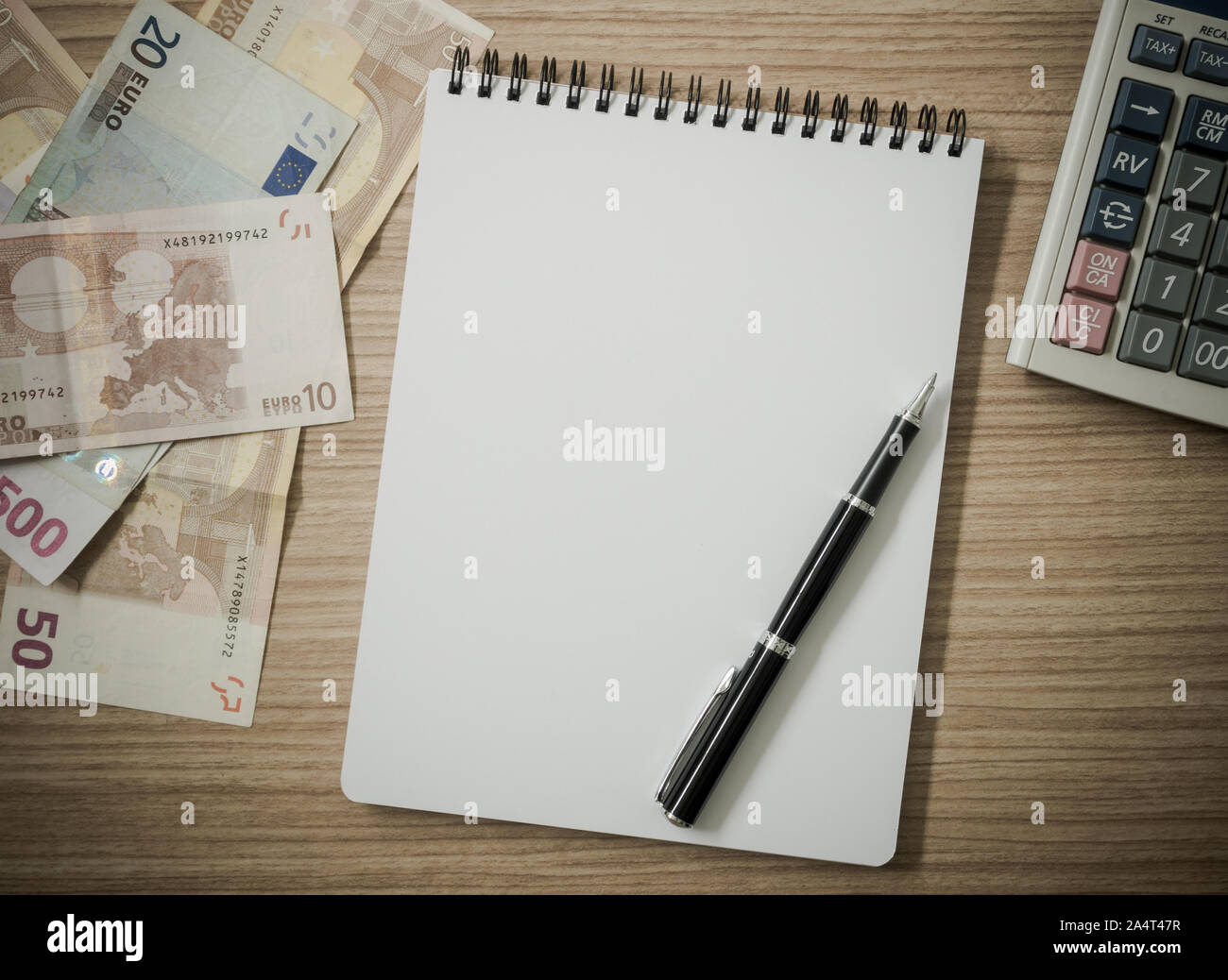 financial Accounting concept. Notebook, pen, banknote and calculator on ...