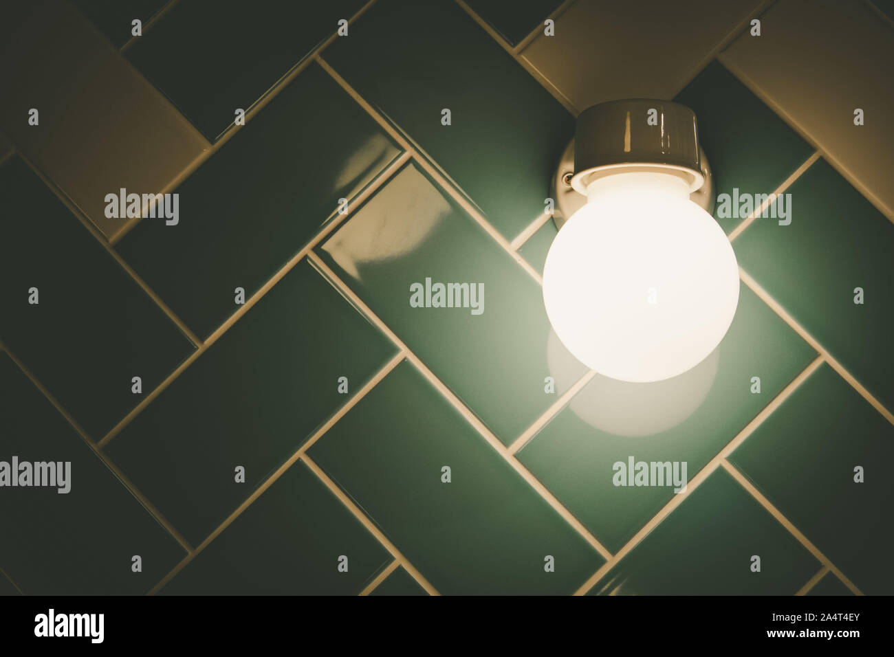 Round light fixture on tiled bathroom wall with copy space Stock Photo ...