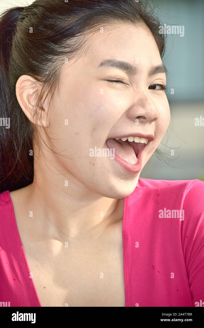 Pretty Chinese Female Winking Stock Photo - Alamy