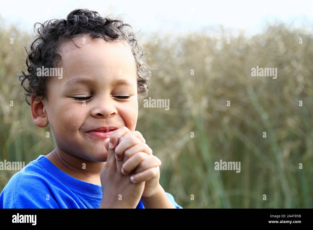 little boy praying to God with hands together stock photo Stock Photo ...