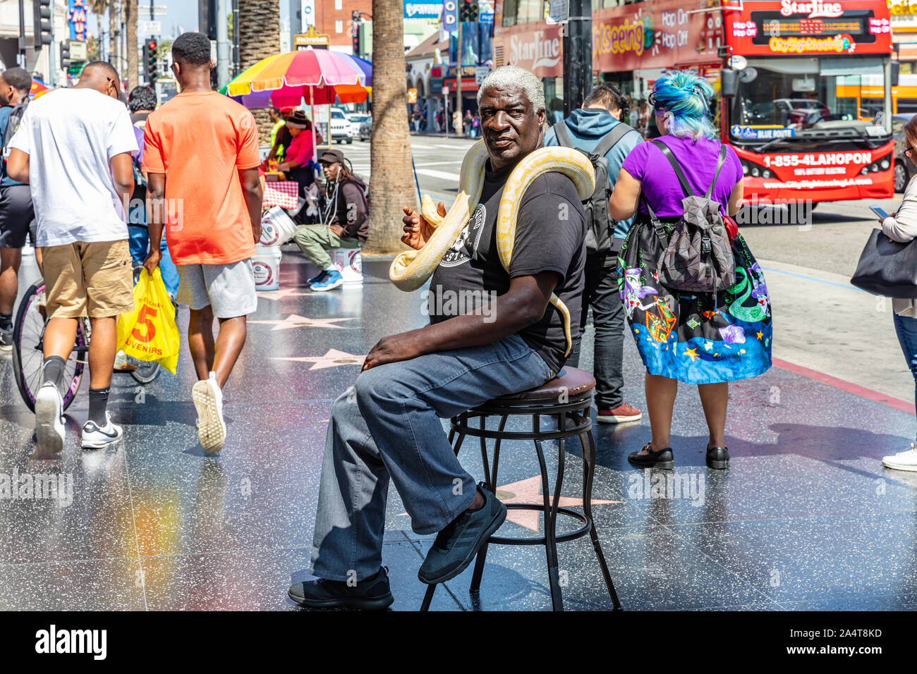 Los Angeles, California, USA. June 1, 2019. Man is sitting on a stool ...