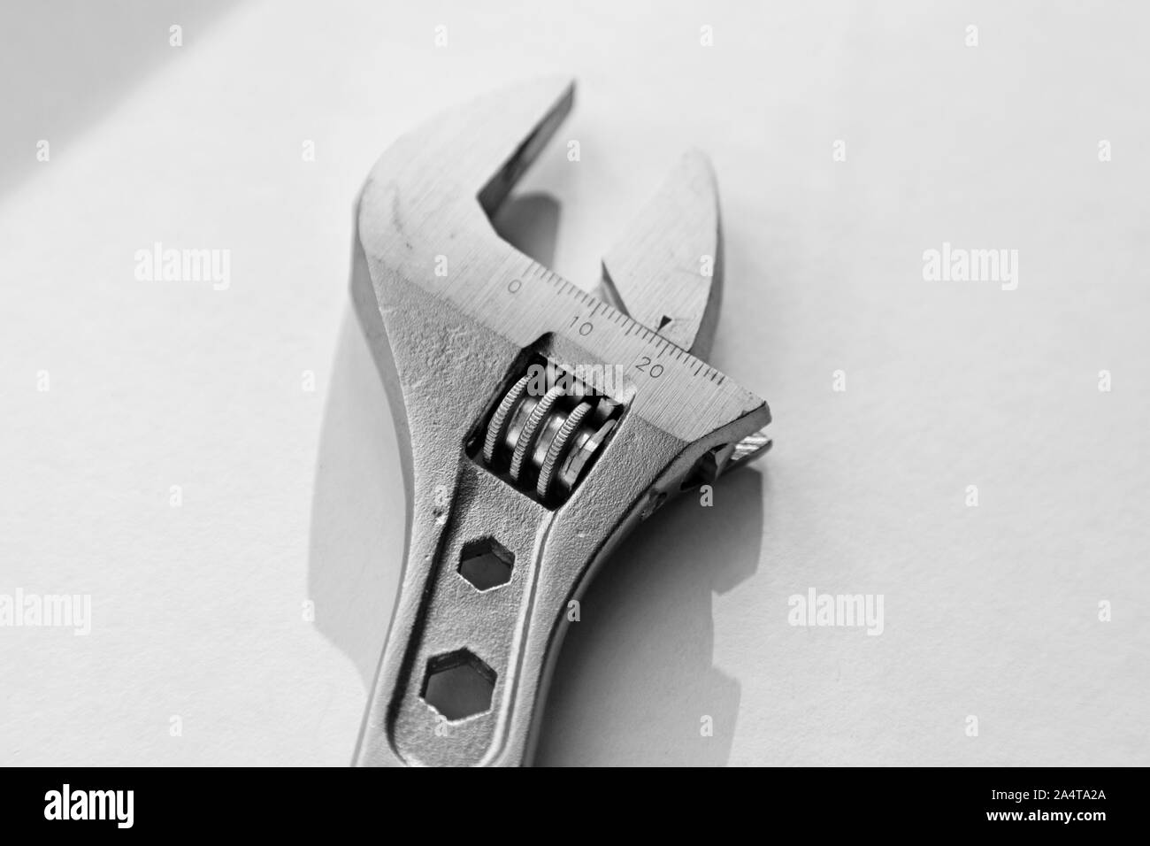 wrench lying on white background with sunlight coming in from window ...