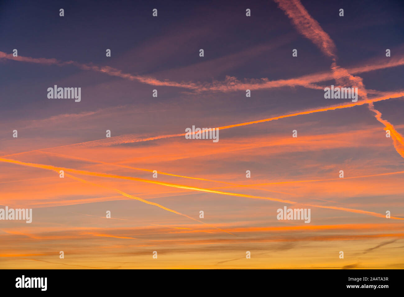 Aircraft contrails in the sky at sunset Stock Photo - Alamy