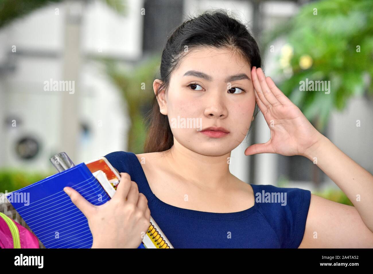Thinking Chinese Female Student Stock Photo - Alamy