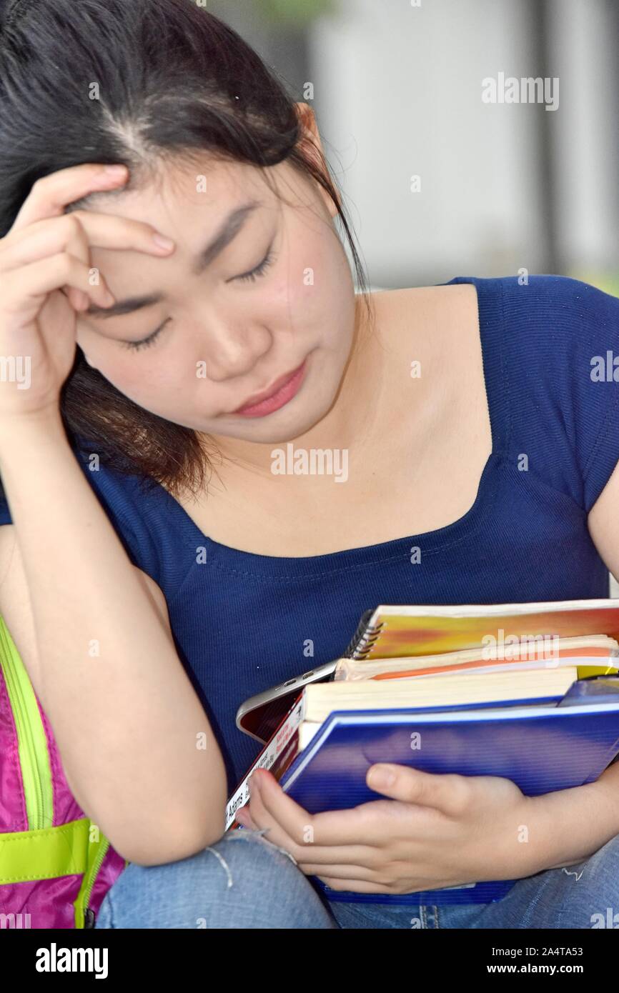 Stressful Young Chinese Female Student With Books Stock Photo - Alamy