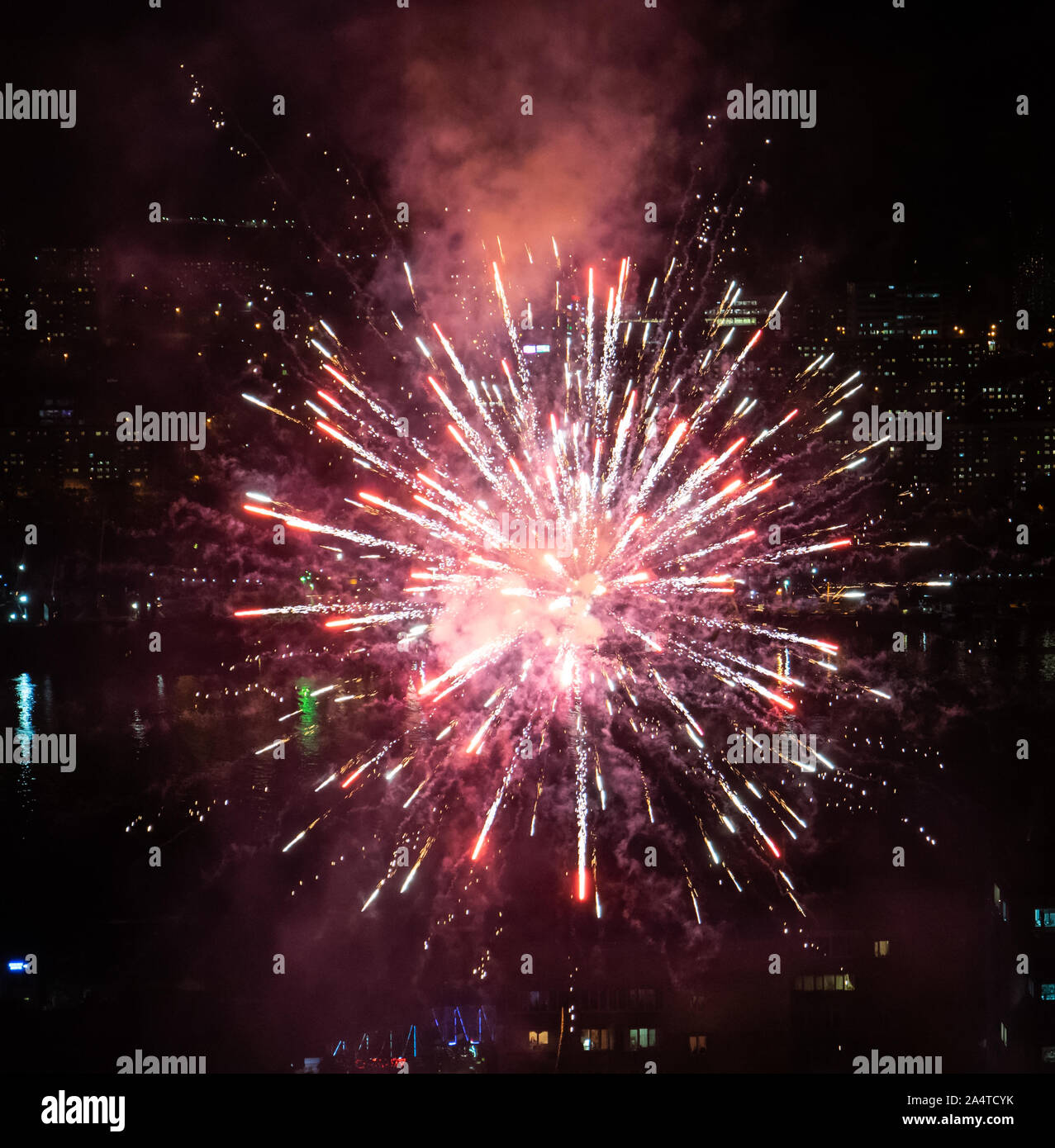 Colorful fireworks over city Stock Photo - Alamy