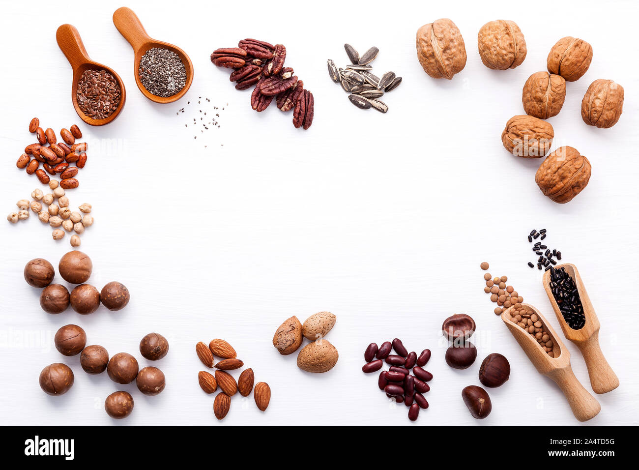 Spoon of various legumes and different kinds of nuts walnuts kernels ...