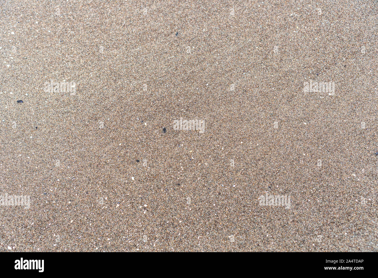 Dark and gray sand on the beach Stock Photo - Alamy