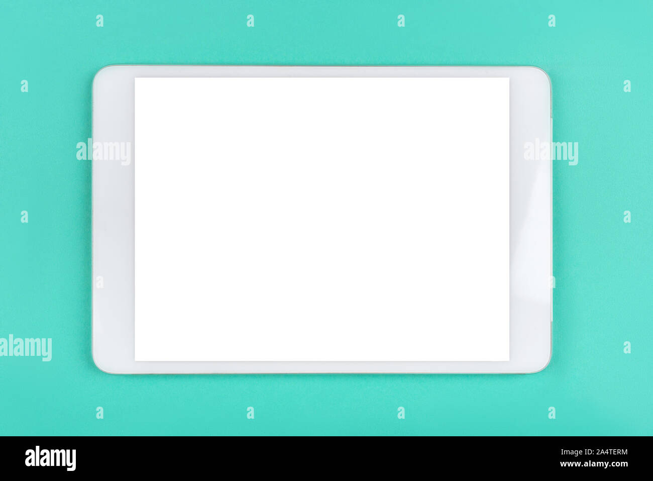White digital tablet on mint background Stock Photo - Alamy