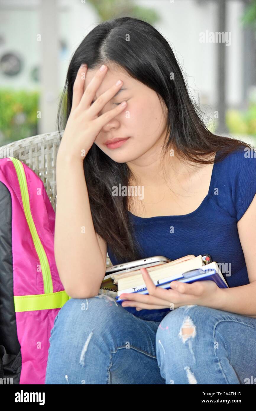 Filipina Girl Student And Sadness With Books Stock Photo - Alamy