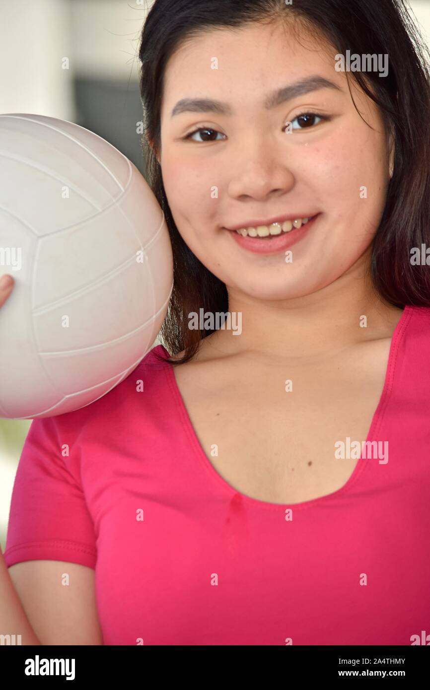 Smiling Fit Female Athlete With Volleyball Stock Photo - Alamy