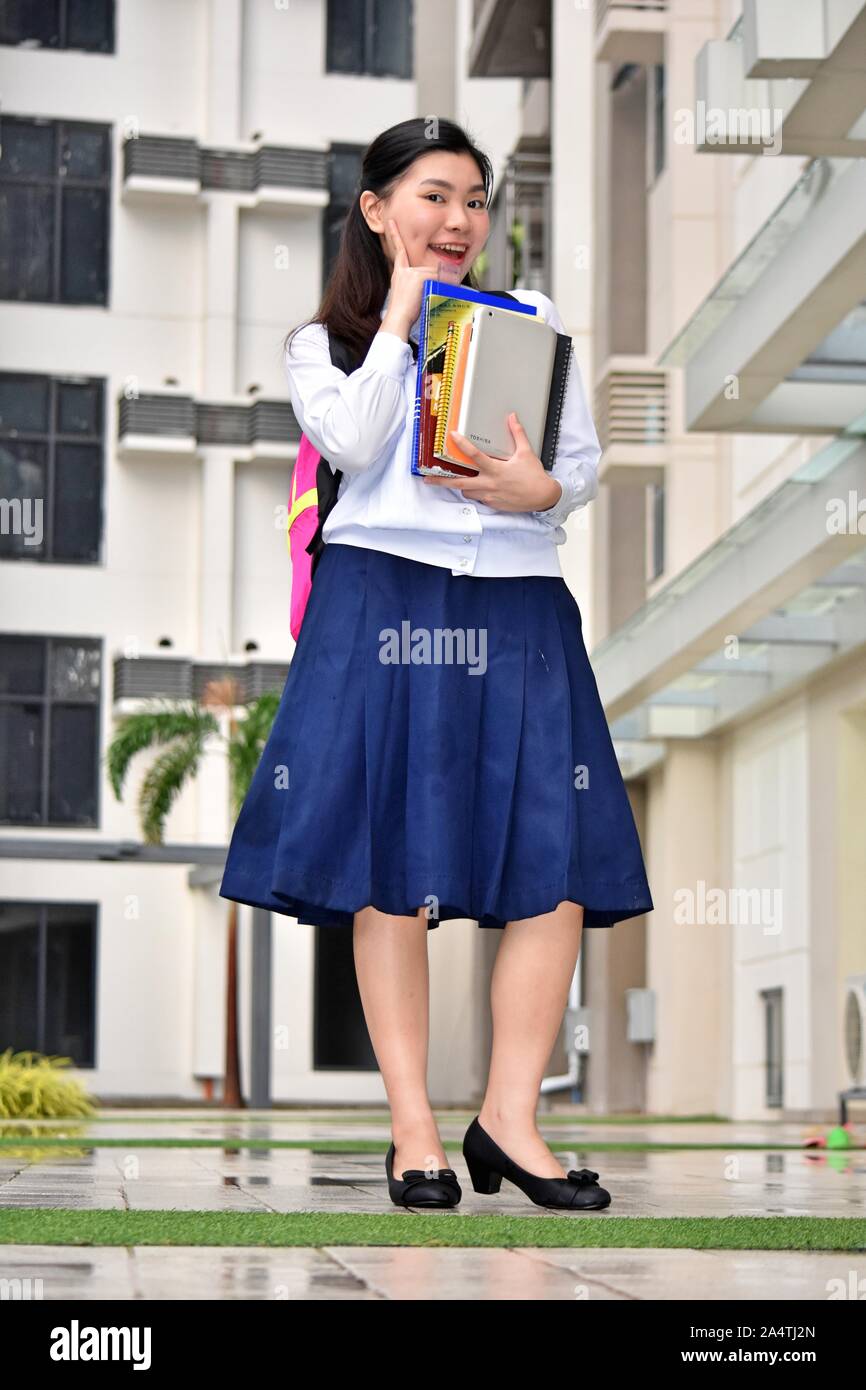 Happy Chinese Student Teenager School Girl With Books Standing On ...