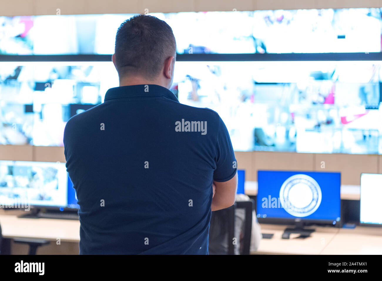 Security guard monitoring modern CCTV cameras in surveillance room ...