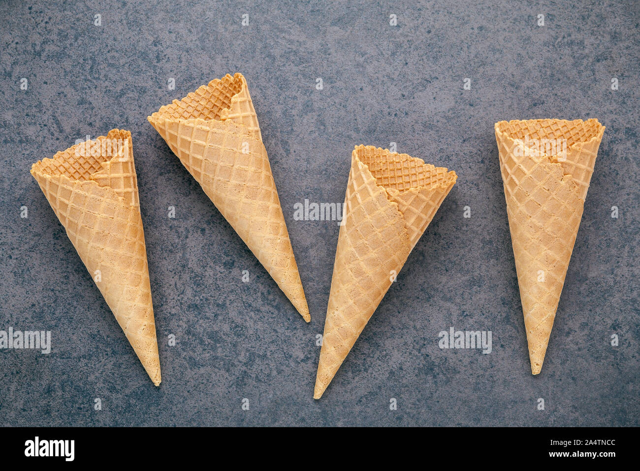 Flat lay ice cream cones collection on dark stone background . Blank ...