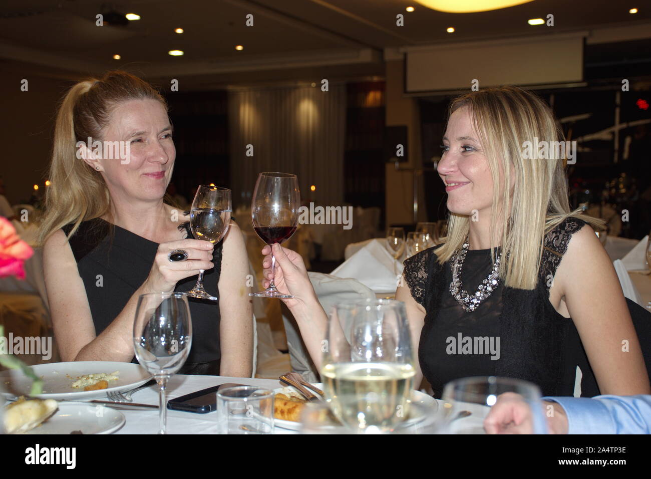 Portrait of mature women having toast in restaurant Stock Photo - Alamy
