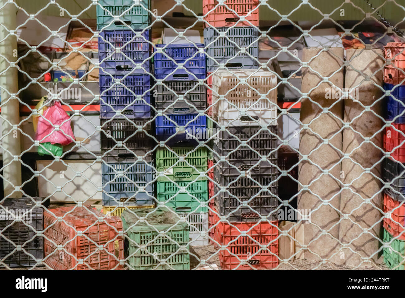 Storage plastic container crates stacked in market. Night view of ...