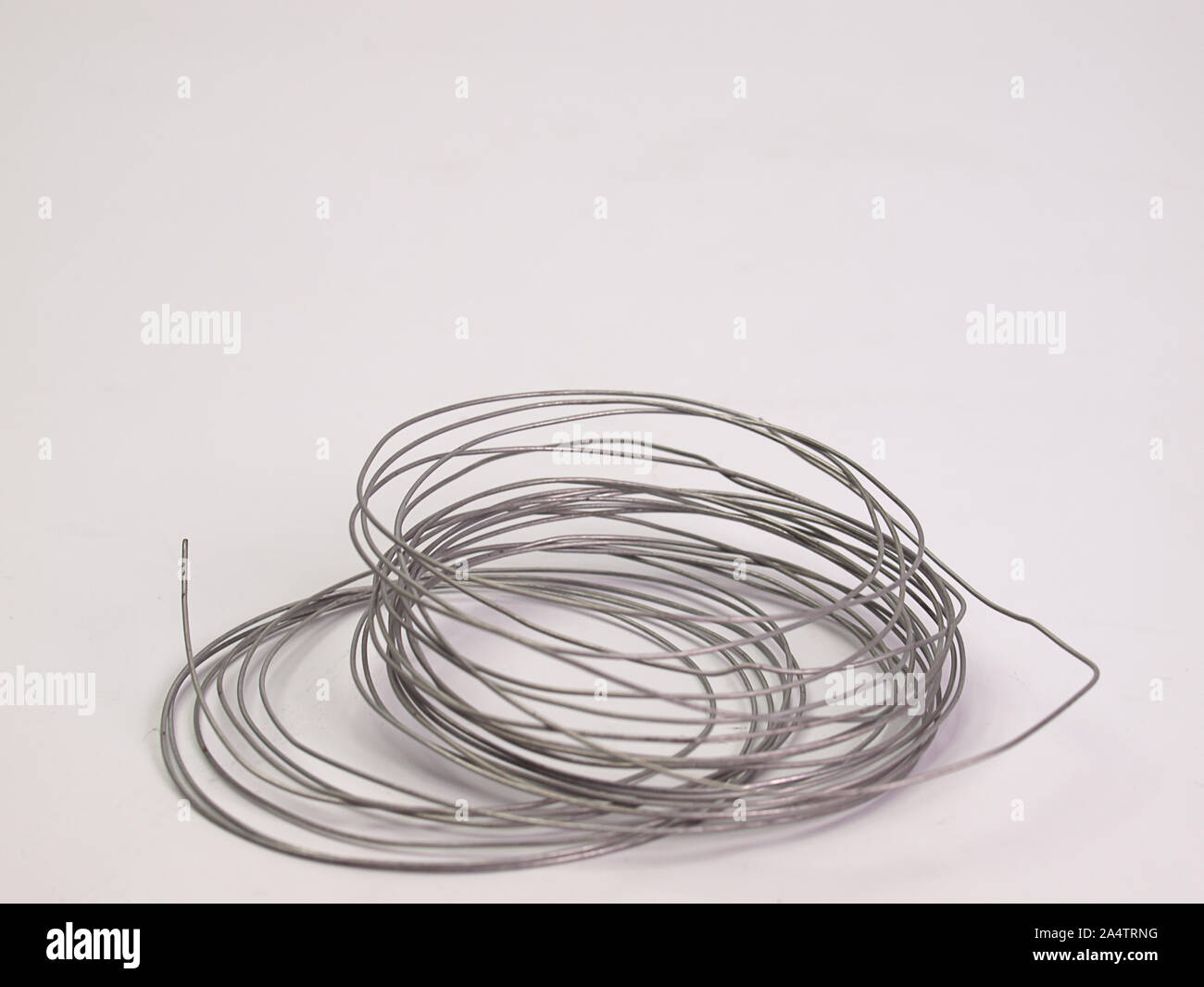roll of metal wire isolated on white Stock Photo - Alamy