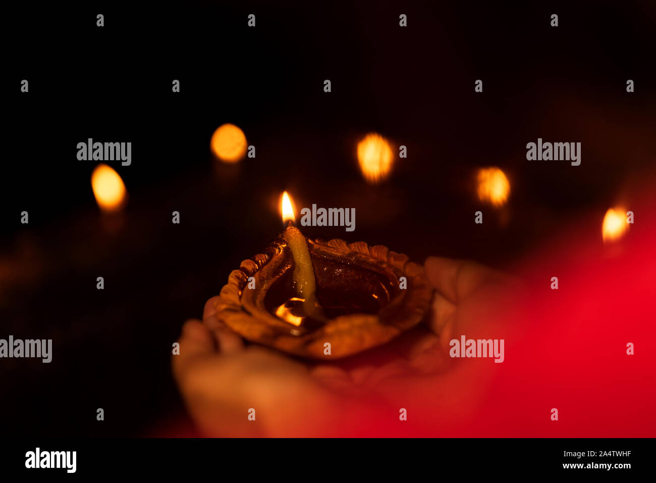 Indian woman or female holding diya or oil lamp in her hand during ...