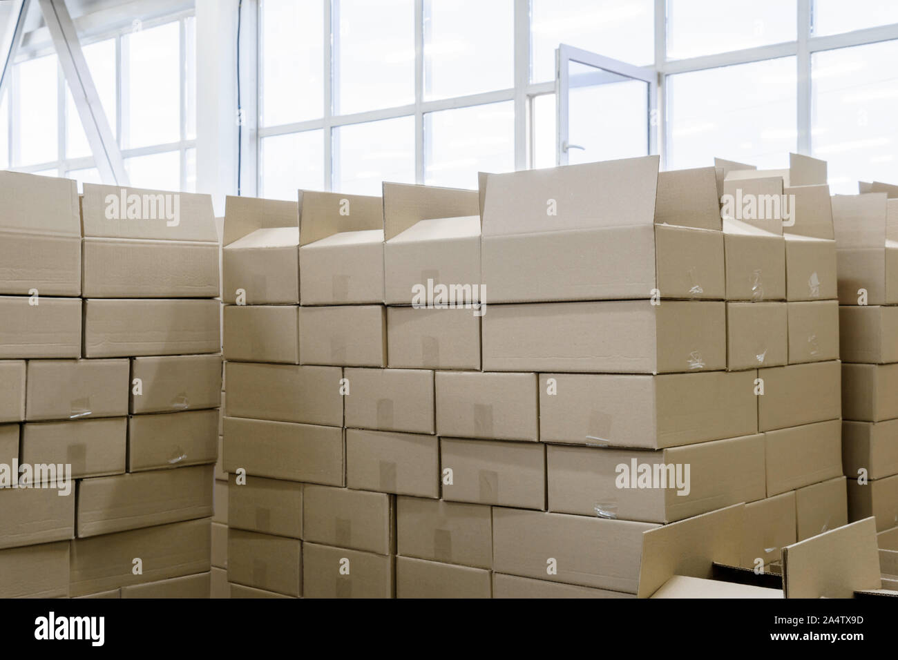 stacks of cardboard boxes with products in the packaging workshop Stock ...