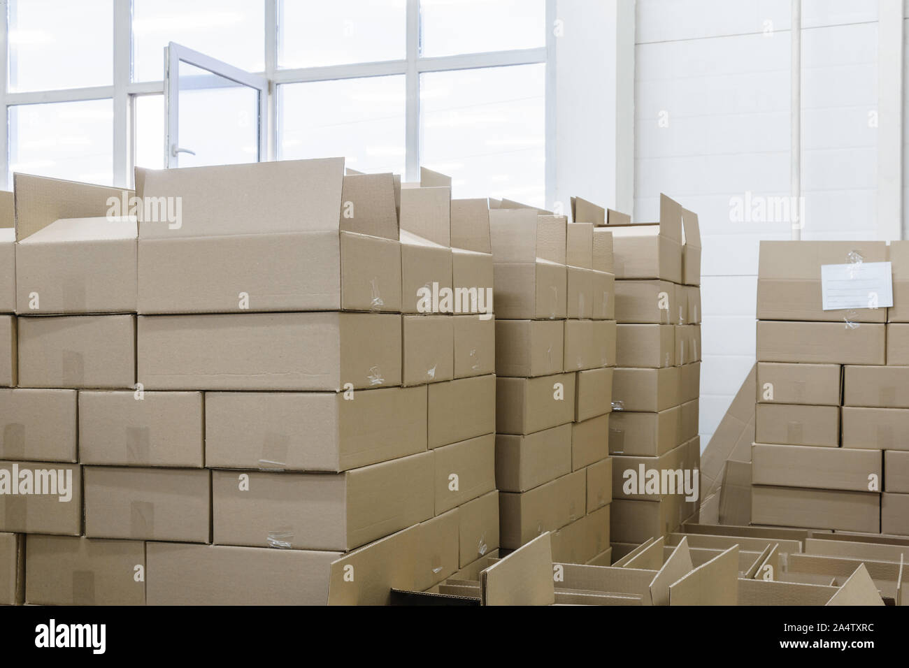 stacks of cardboard boxes with products in the packaging workshop Stock ...