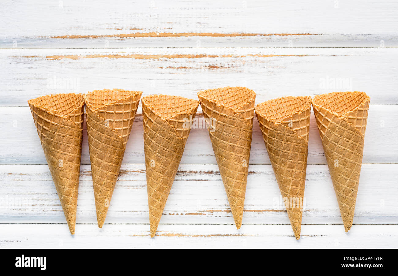 Flat lay ice cream cones collection on white wooden background . Blank ...