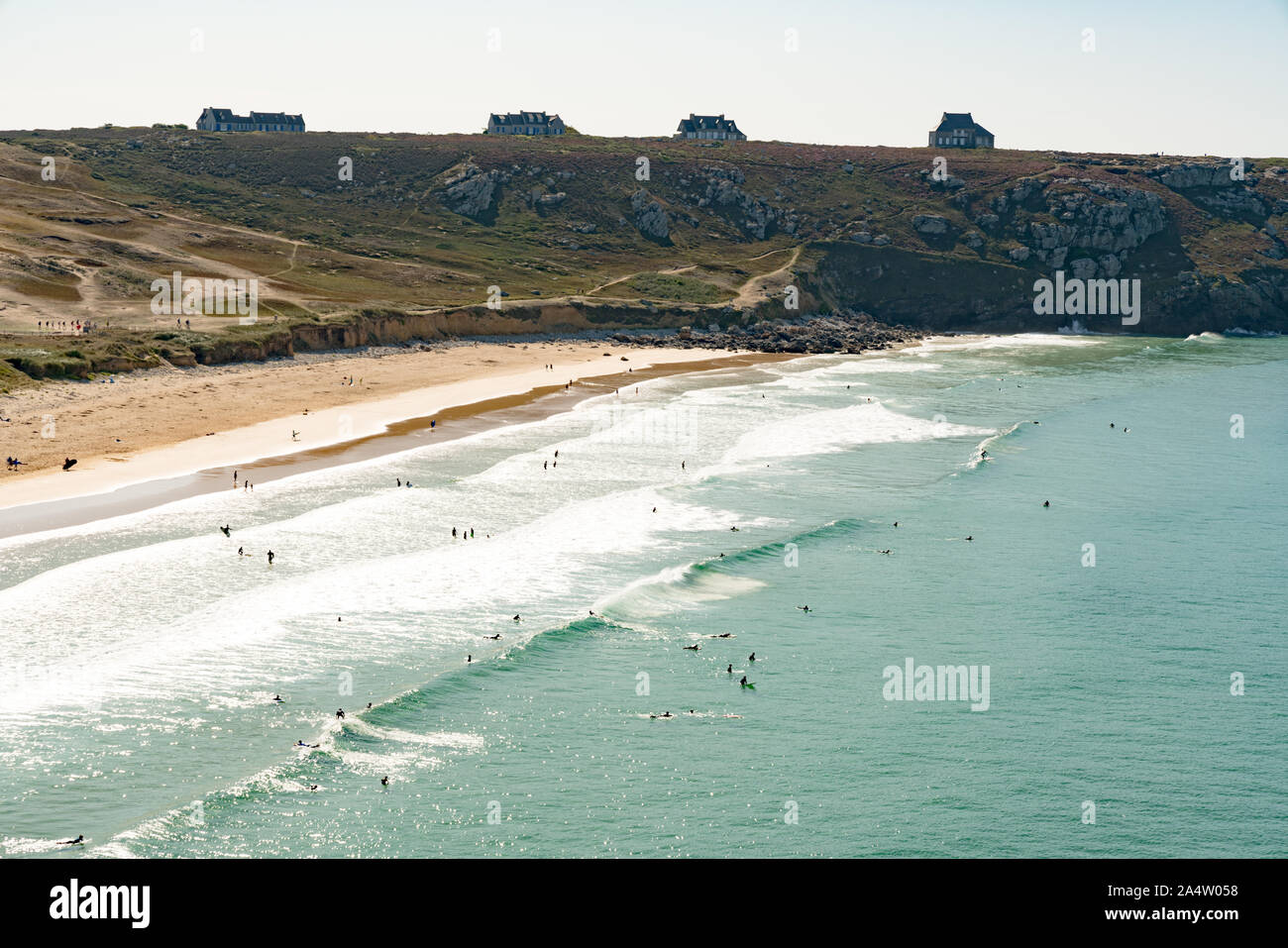 A view of the Plage de Pen Hat beach and bay with many surfers surfing ...