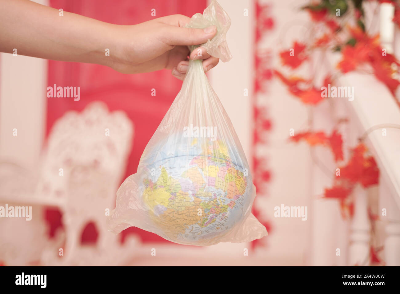 horizontal photo of a teenager's hand holding a planet in a bag ...