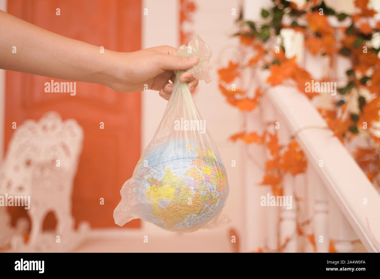 horizontal photo of a teenager's hand holding a planet in a bag ...