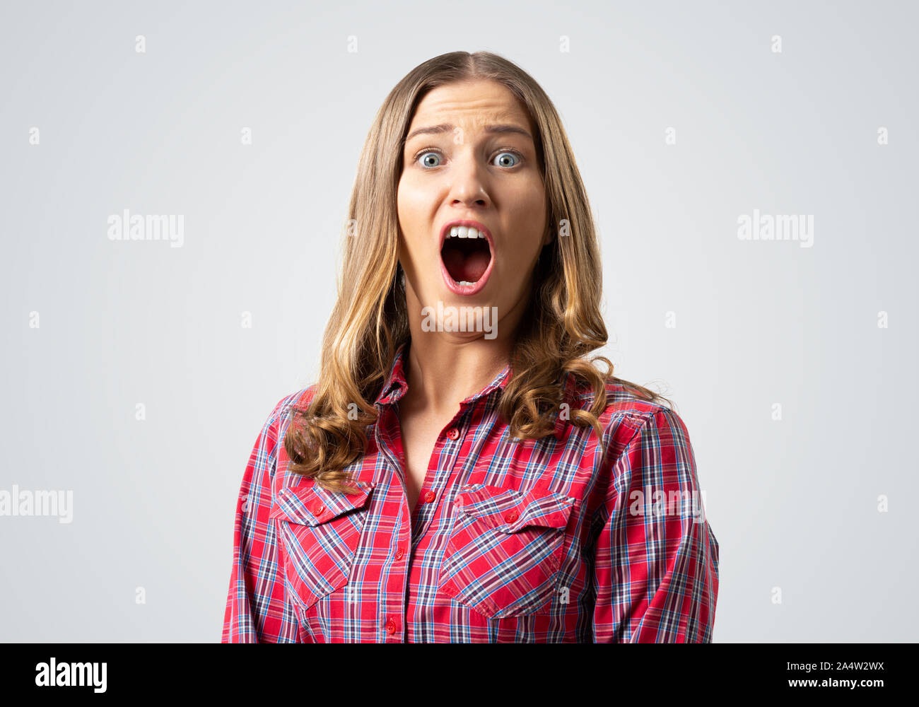 Scared young woman screaming with panic. Emotional girl has frightened ...