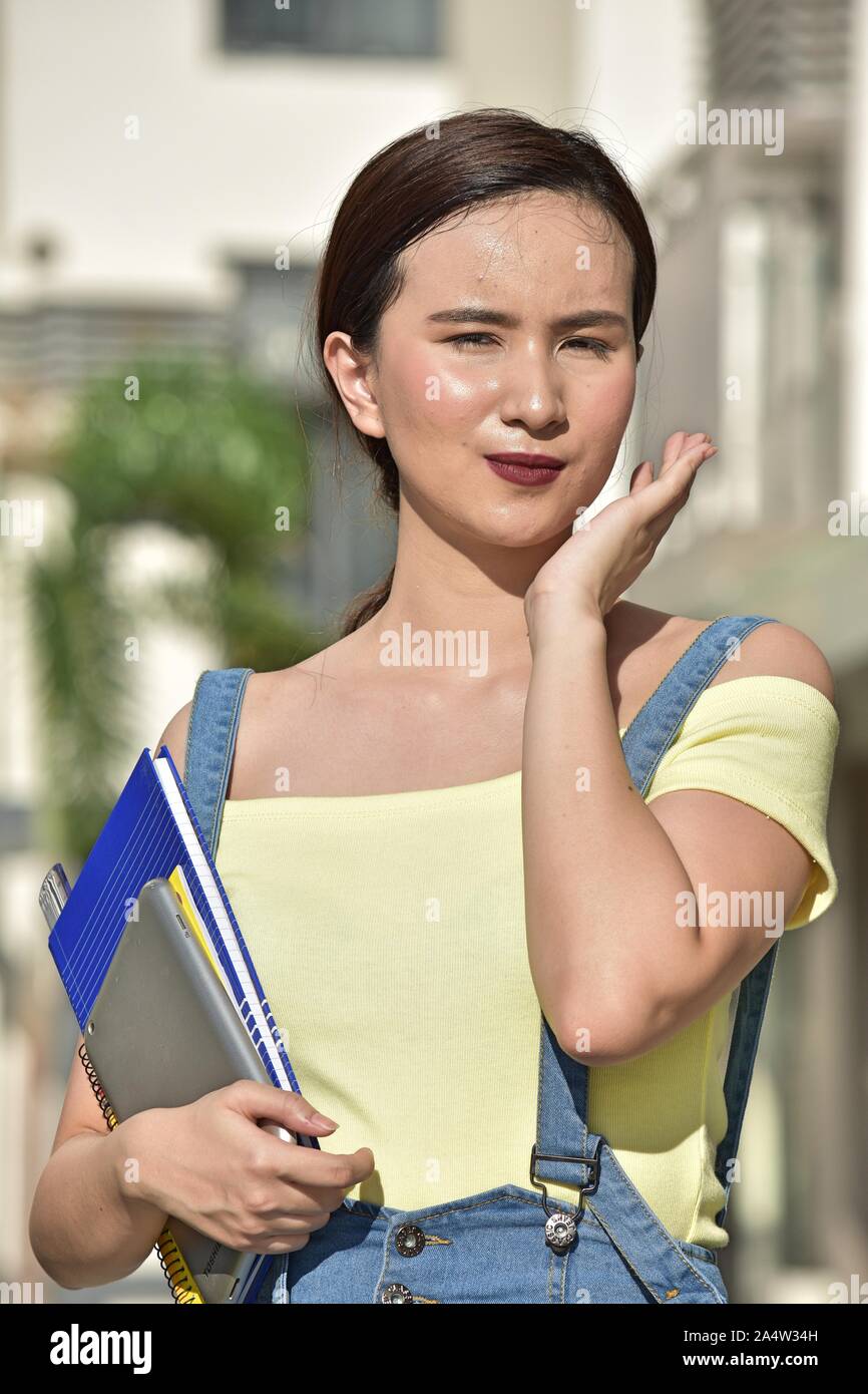 Cute Youthful Asian Person With Notebooks Stock Photo - Alamy