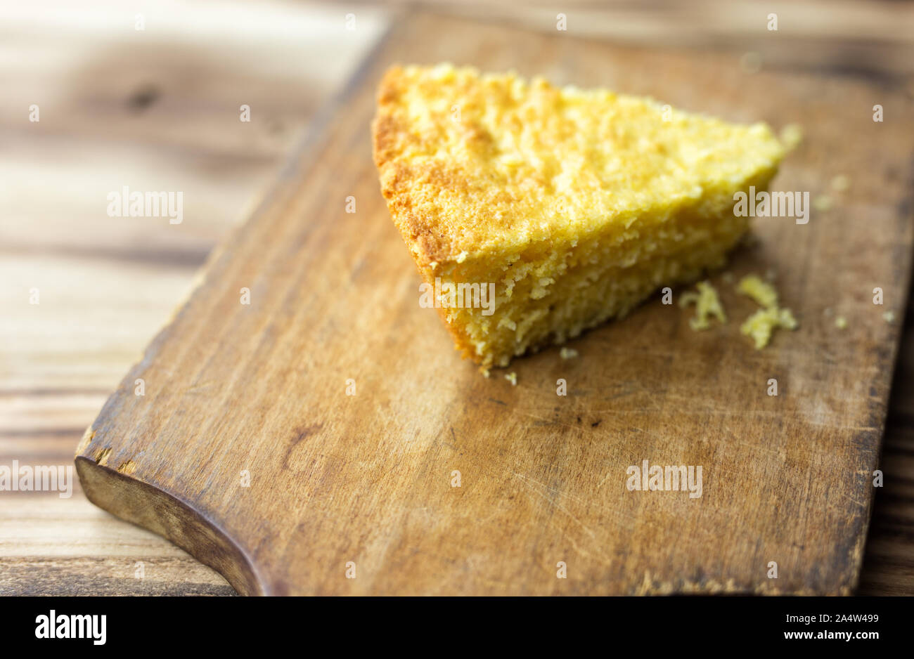 Single piece of cornbread on a small wooden cutting board Stock Photo ...