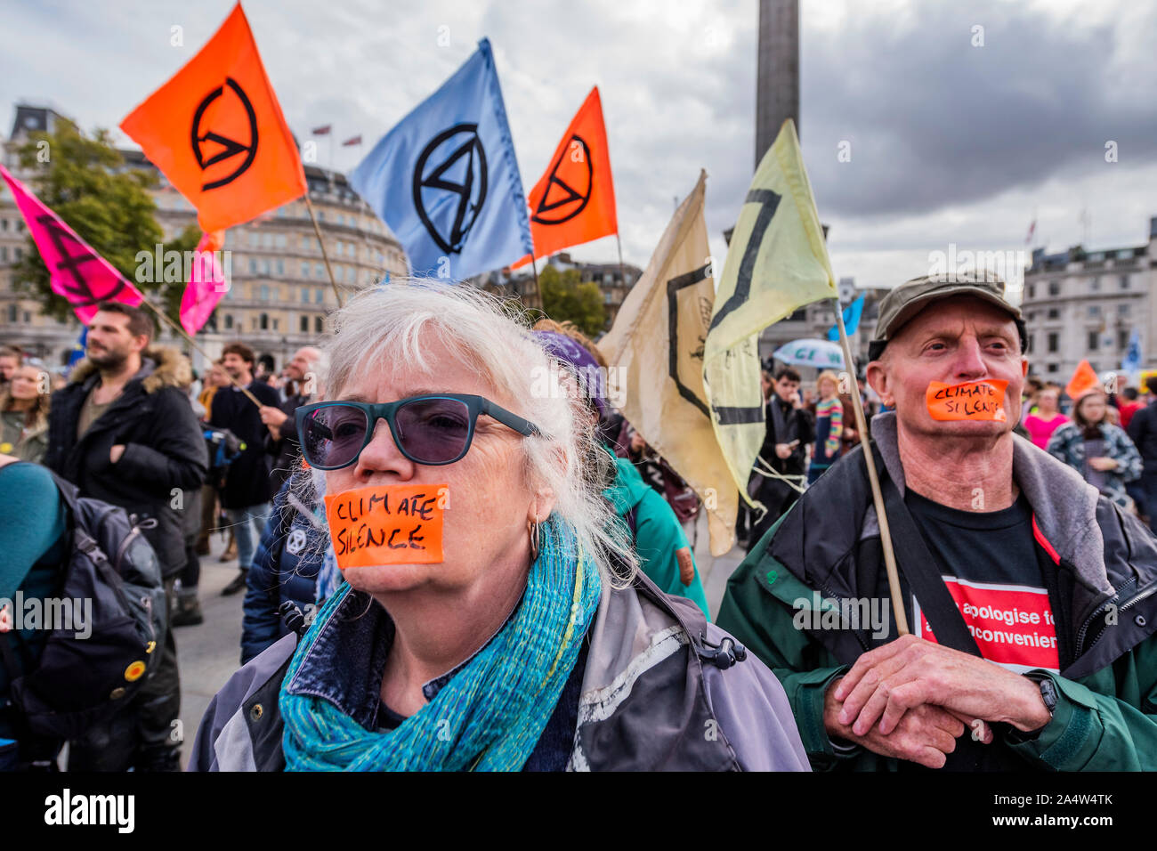 London, UK. 16th Oct 2019. Many put tape over thei mouth as they ...