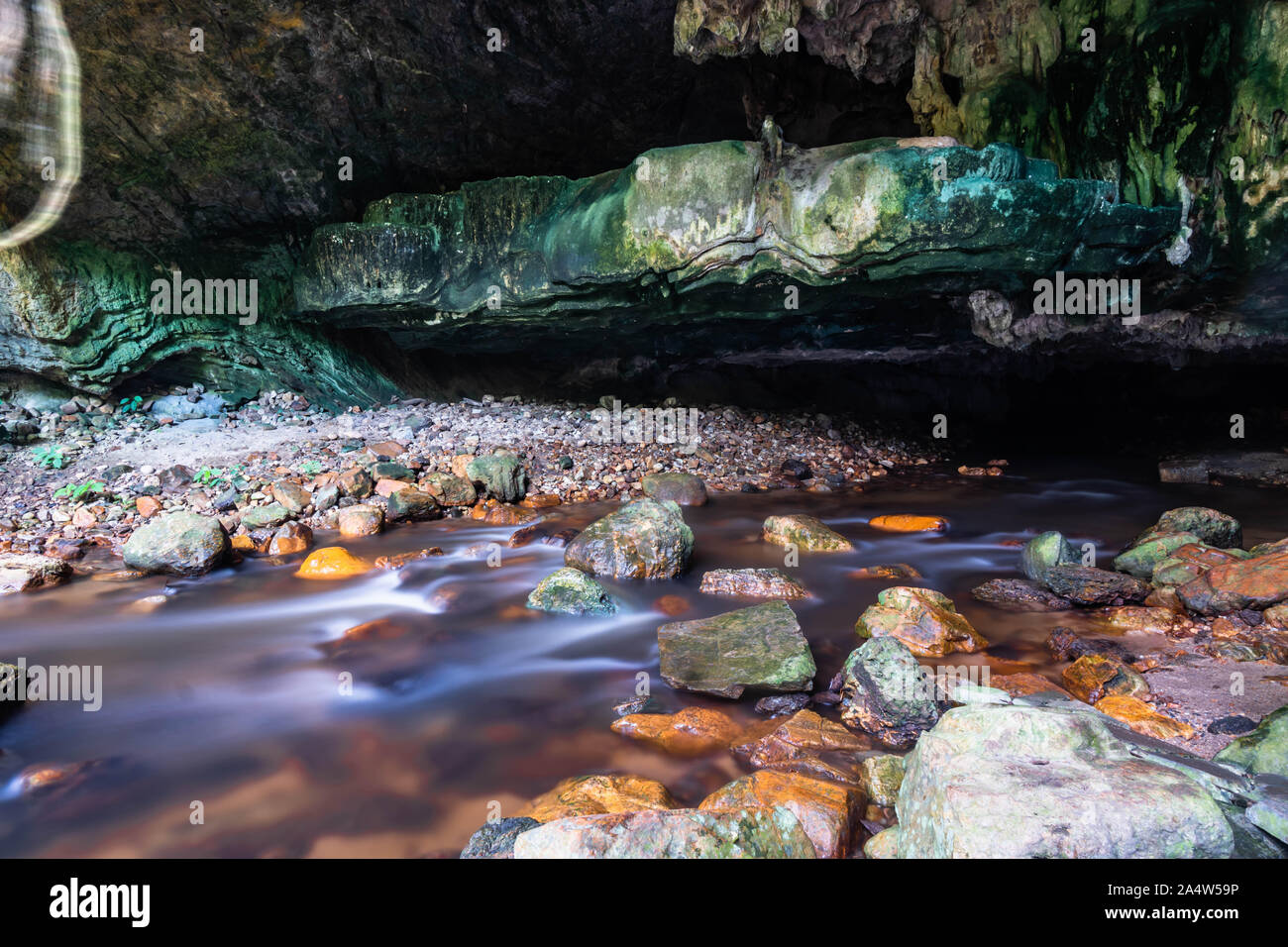 Small waterfall with stone and foliage in the cave Stock Photo - Alamy