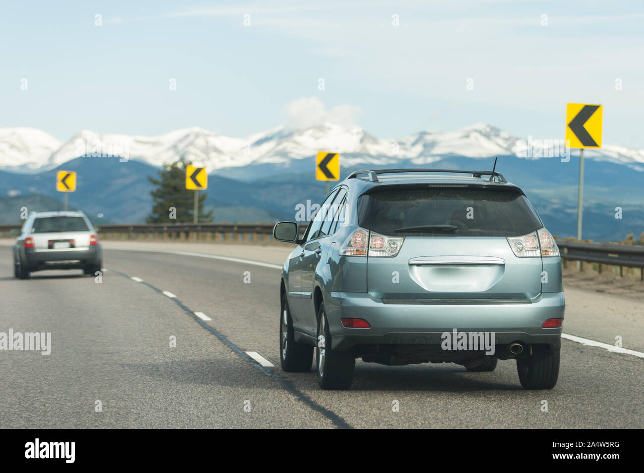 Sport utility vehicle driving on interstate highway going through snow ...