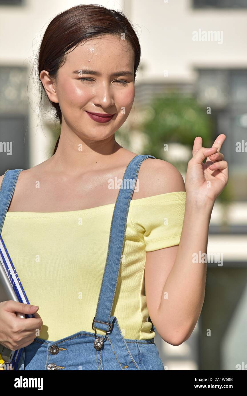 Young Diverse School Girl And Peace Sign With Books Stock Photo - Alamy