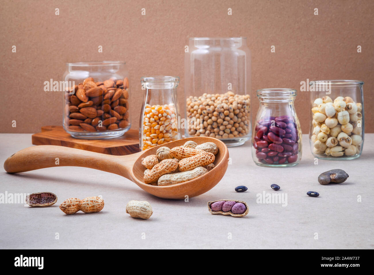 Various beans and nuts in the glass on brown background. mung bean ...