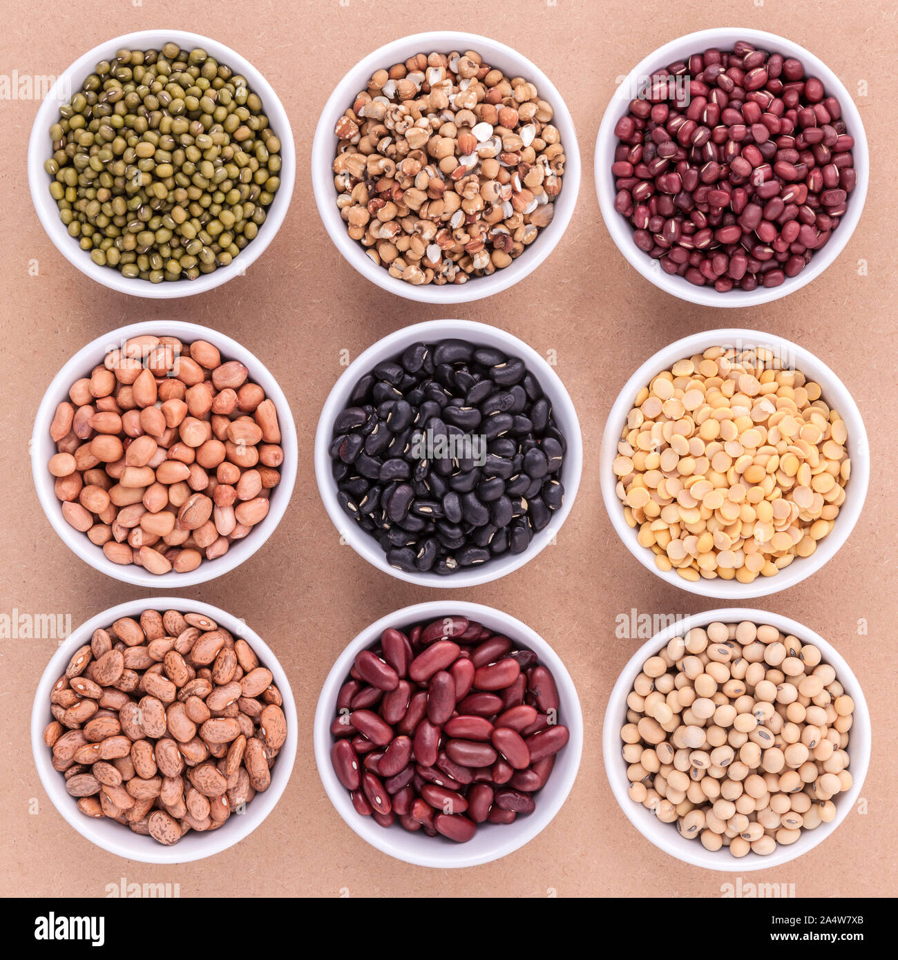 Mixed beans and lentils in the white bowl on brown background. mung ...