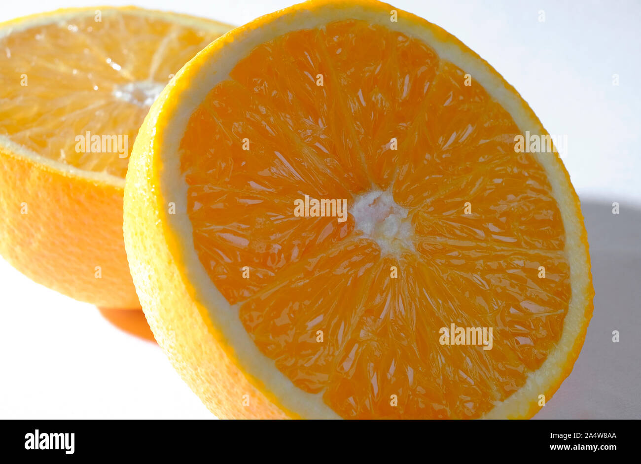 orange halves on white background Stock Photo - Alamy