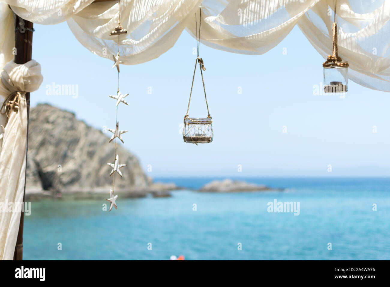 View to the sea from a beach bar, with canopy, lantern and stars ...