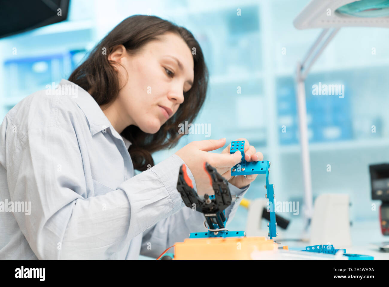 Student woman in robotics laboratory working on project mechatronics ...