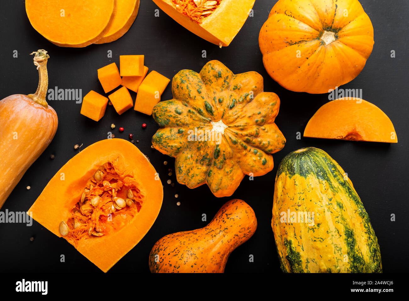 Different types of pumpkins on a black background. Top view Stock Photo ...