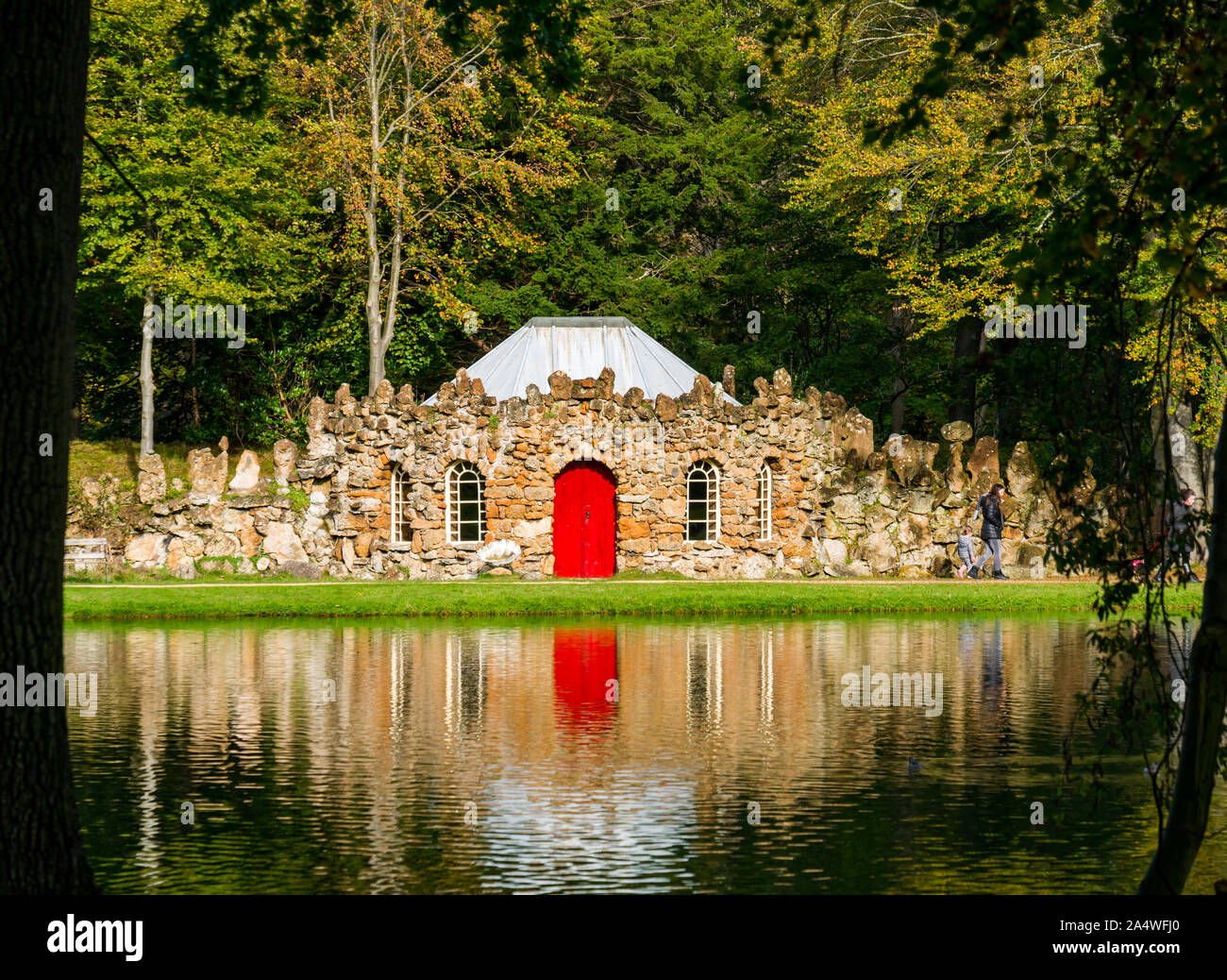 Quirky unusual rubble stone curling lodge reflected in artificial lake ...