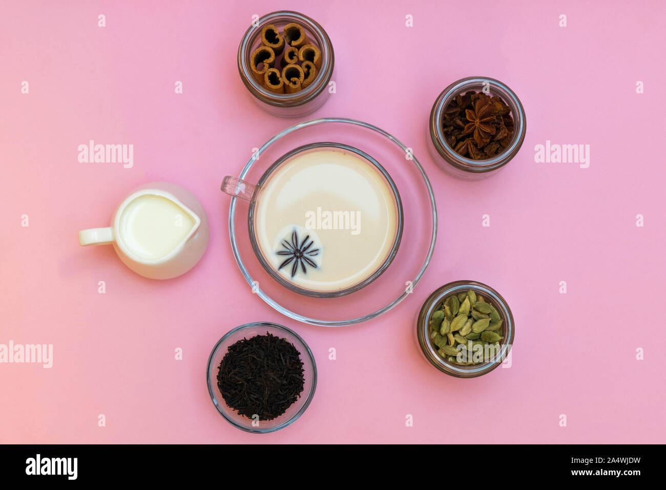 Milk tea masala chai with ingredients on pink background, top view ...
