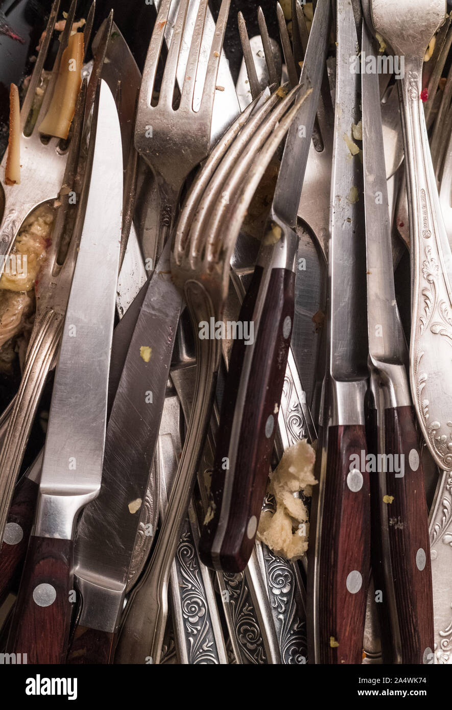 pile of after dinner dirty silver cutlery Stock Photo - Alamy