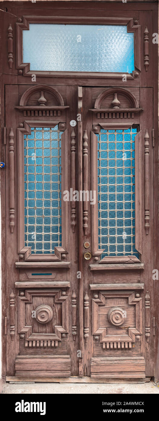 Old wooden door with carved ornaments. Frontal view Stock Photo - Alamy