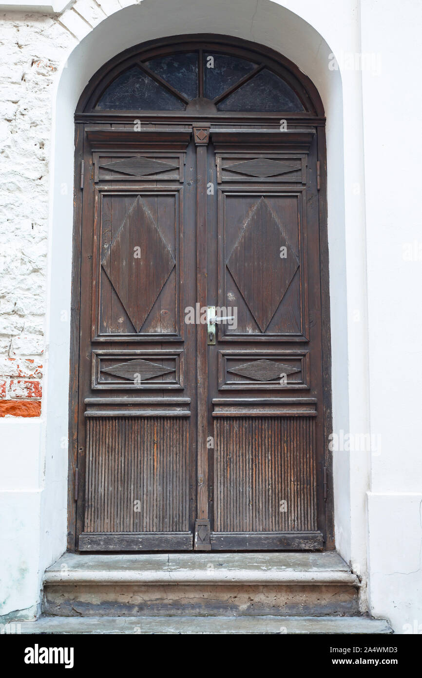 Old wooden door with carved ornaments. Frontal view Stock Photo - Alamy
