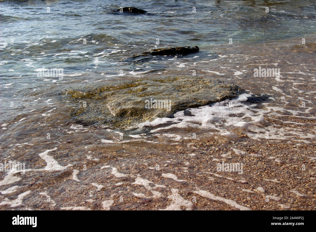 Summer background of hot sand with sea or ocean wave bubbles with copy ...