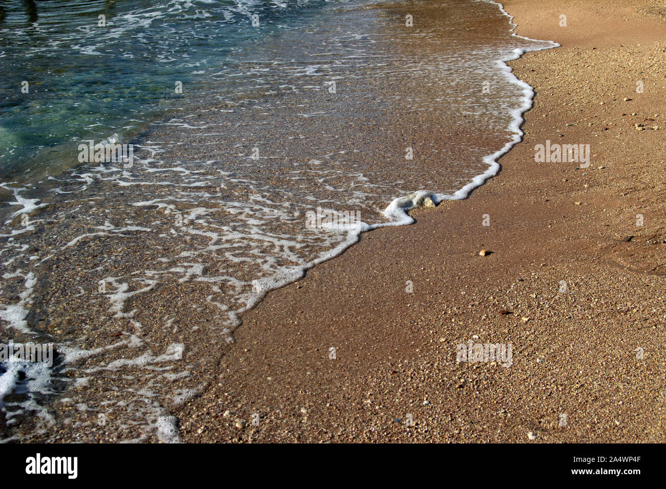 Summer background of hot sand with sea or ocean wave bubbles with copy ...