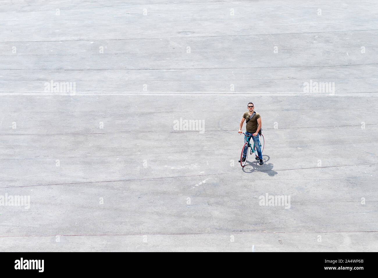 Young man standing with his bike on a square ( Copyspace Stock Photo ...