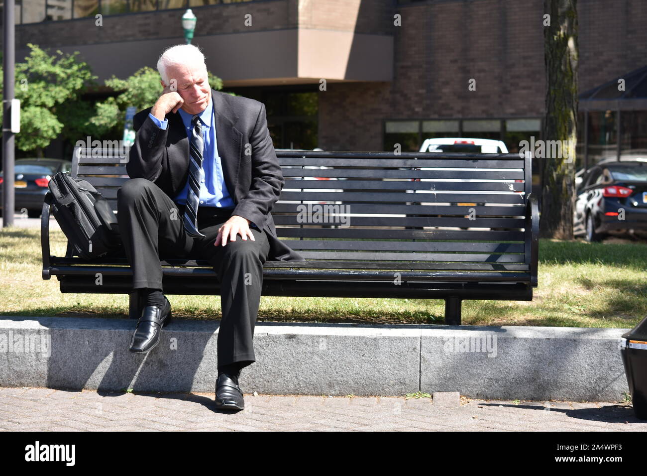 Sad Business Man Wearing Suit Sitting On Bench Stock Photo - Alamy